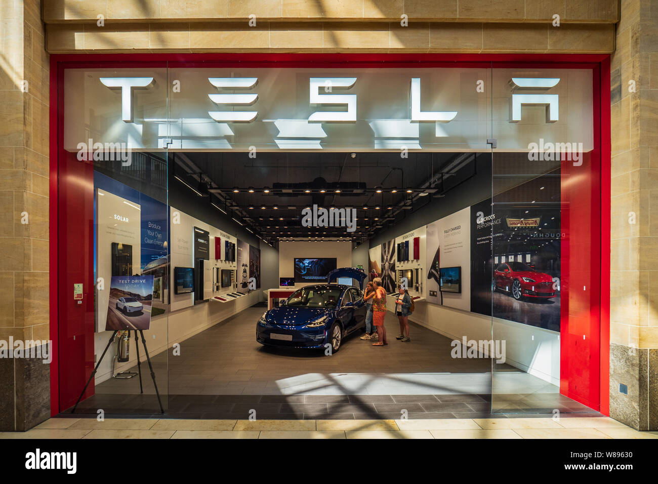 Tesla Model 3 Tesla Showroom - shoppers view the new Tesla Model 3 ...