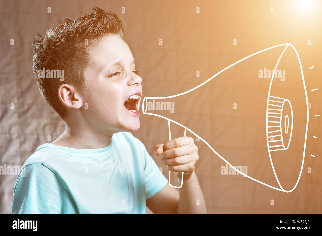 a boy painted with a loudspeaker shouting at him Stock Photo - Alamy