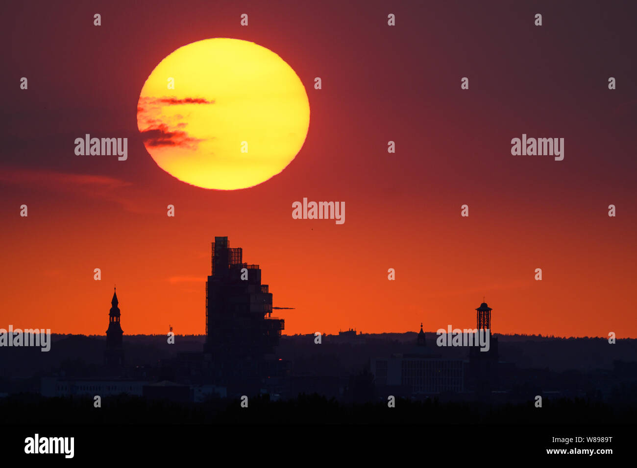 Hanover, Germany. 08th Aug, 2019. The sun sets behind the skyline of ...