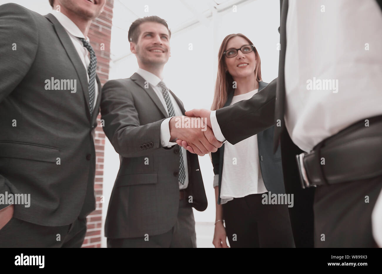 Business shaking hands in the office Stock Photo - Alamy