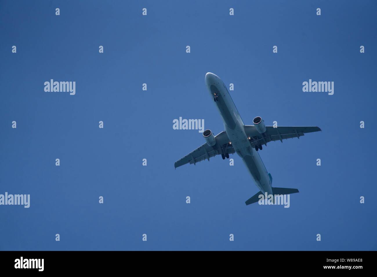 Starting airplane into a blue sky Stock Photo - Alamy