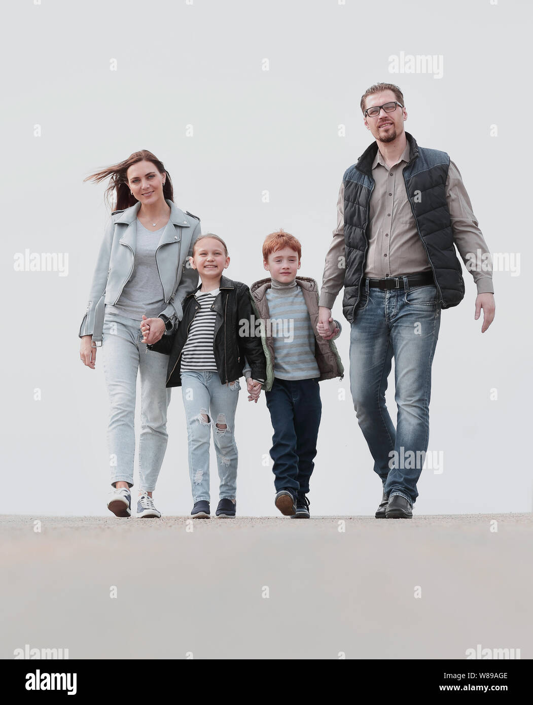 parents with their children walking along together Stock Photo - Alamy