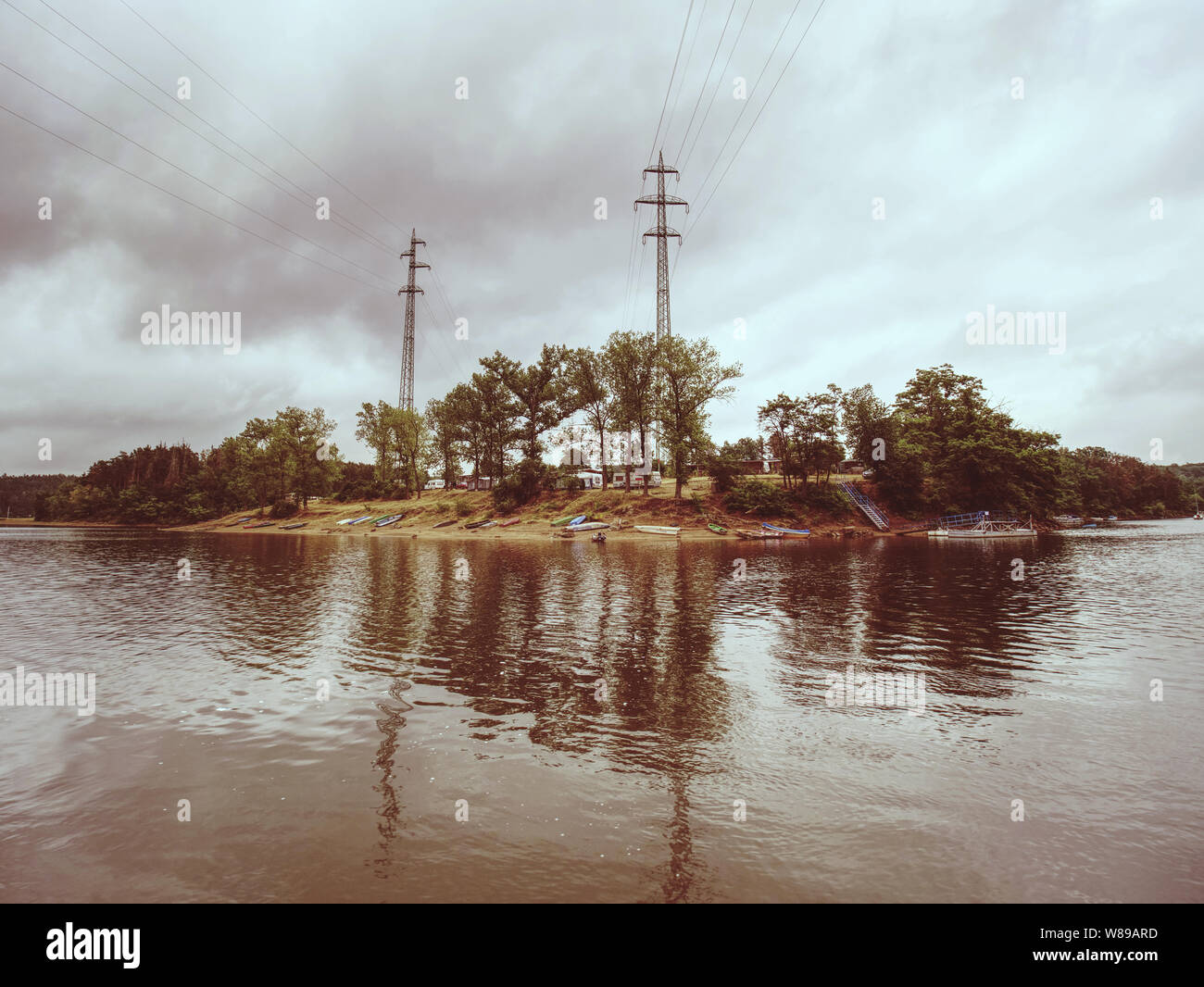 Power lines built on small island in water. Technological progress ...