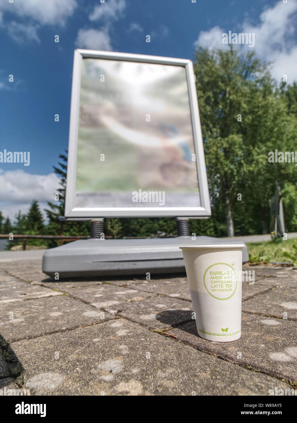 Holiday coffee cup. Aromatic coffee in takeaway paper cup on pavement ...