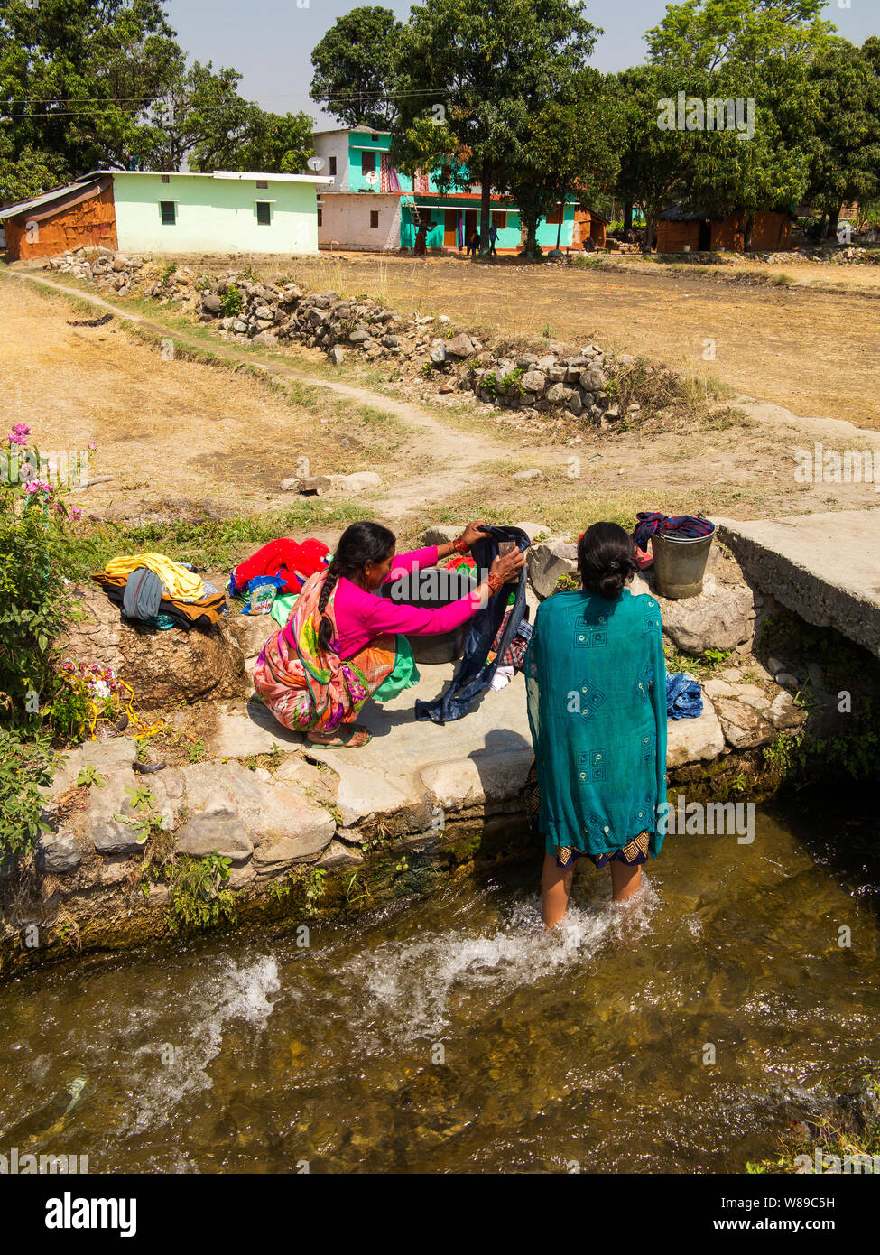 Indian woman washing clothes at the canal at Pawalgarh village ...