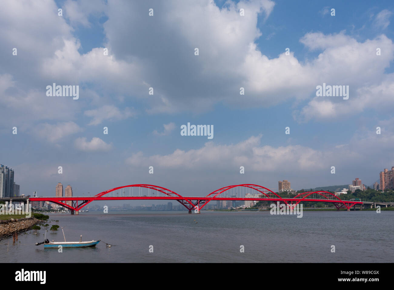 A view of the Guandu Bridge, long red arch bridge over the Tamsui River ...