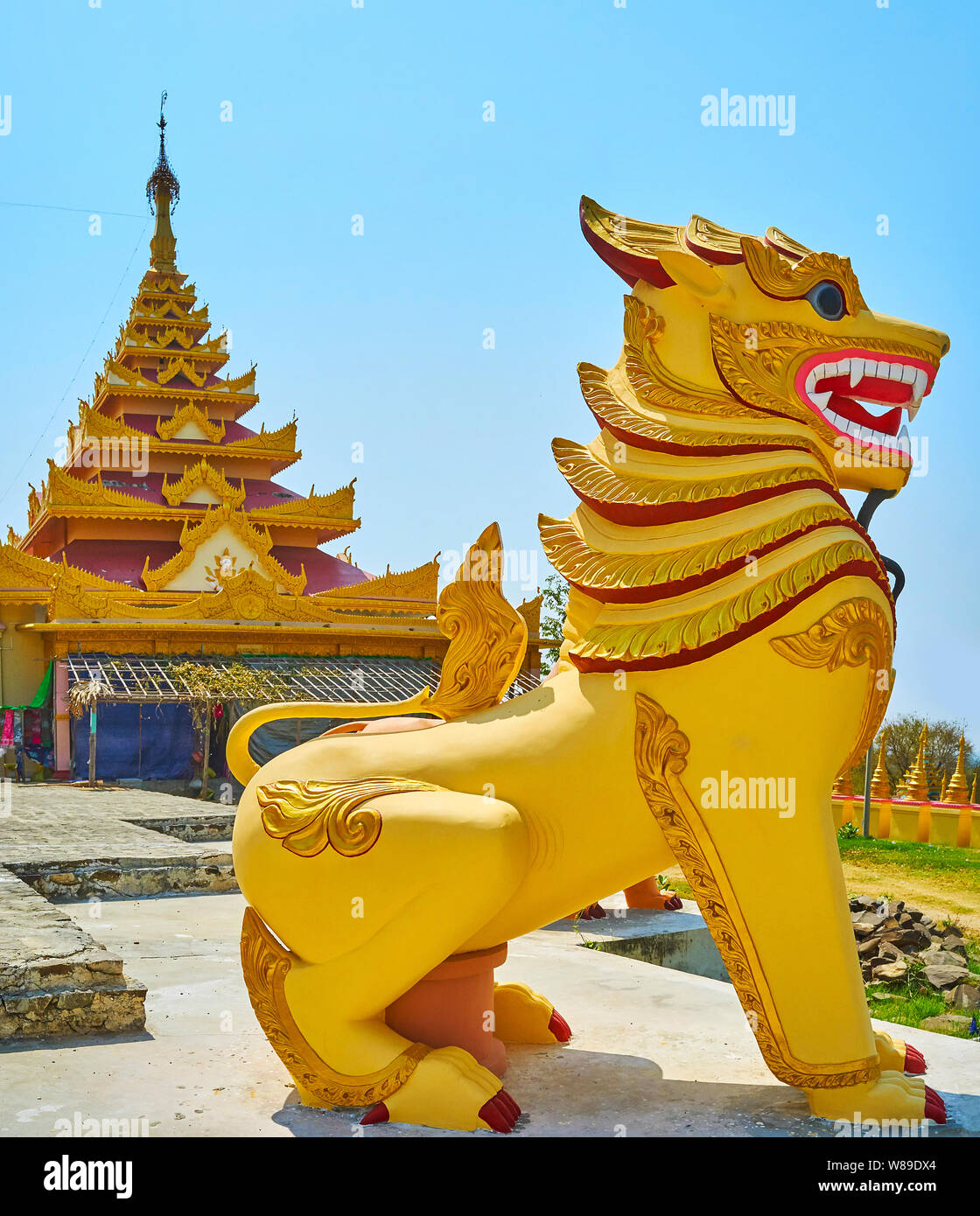The carved chinthe lion in front of the Image house of Aung Sakkya ...