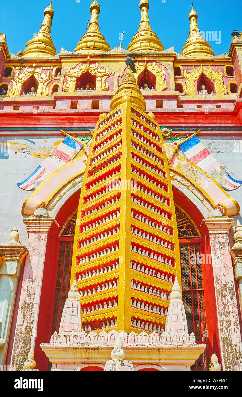 The top of small pagoda at Thanboddhay Pagoda, decorated in red and ...