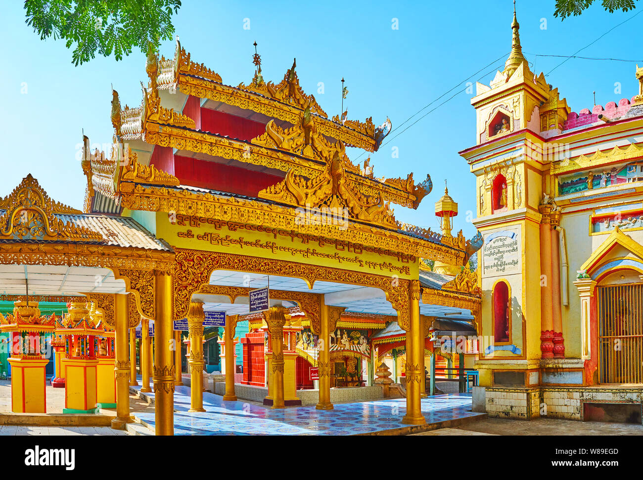 MONYWA, MYANMAR - FEBRUARY 22, 2018: The carved golden gate with ...