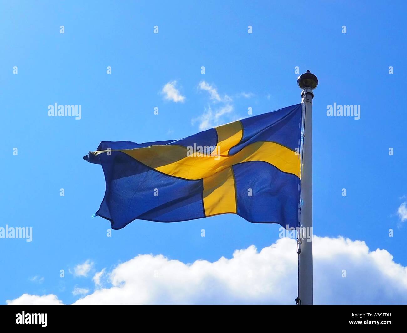 The swedish flag waving in the wind Stock Photo - Alamy