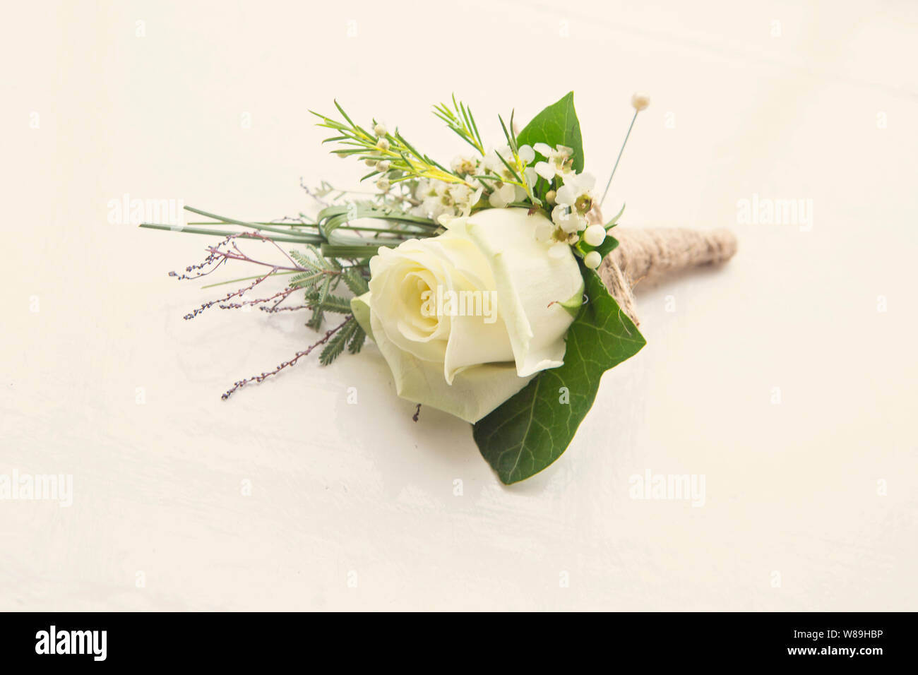 White Rose Button Hole Stock Photo - Alamy