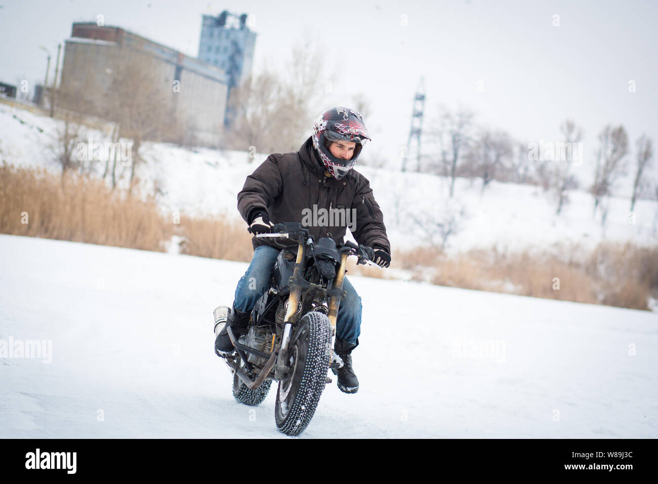 A guy rides a motorcycle on a frozen lake Stock Photo - Alamy