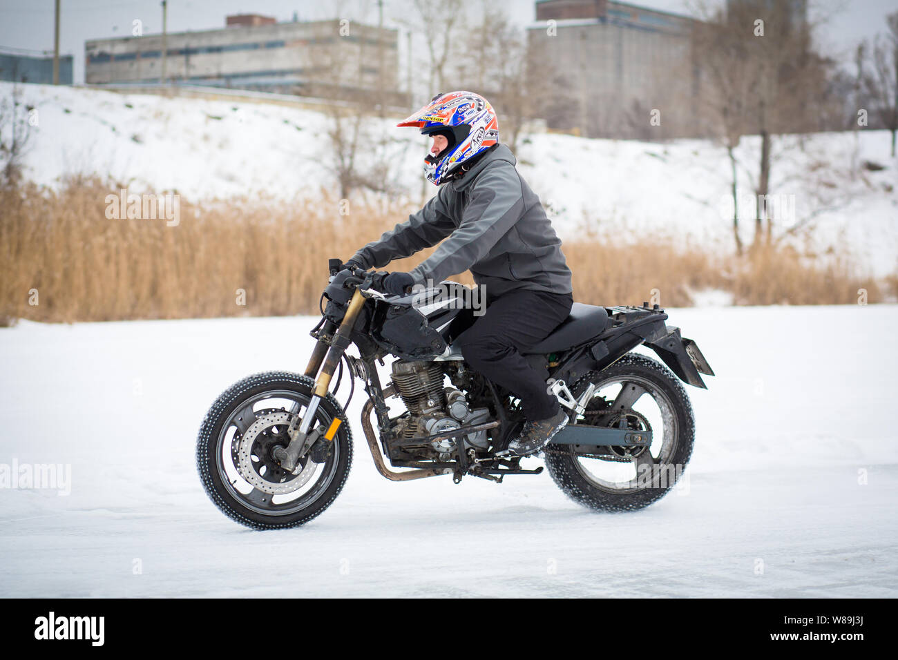 A guy rides a motorcycle on a frozen lake Stock Photo - Alamy