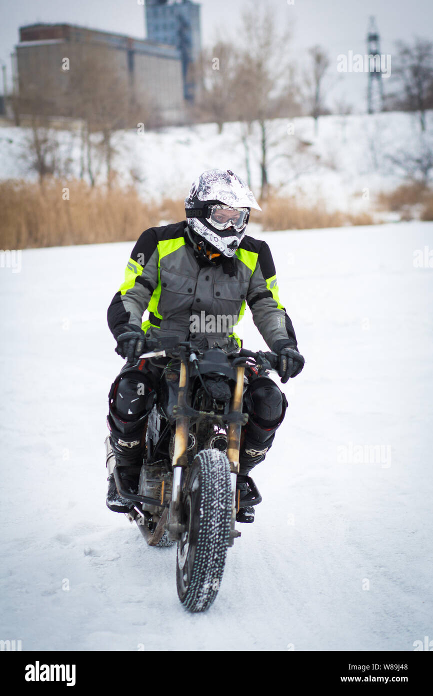 A guy rides a motorcycle on a frozen lake Stock Photo - Alamy