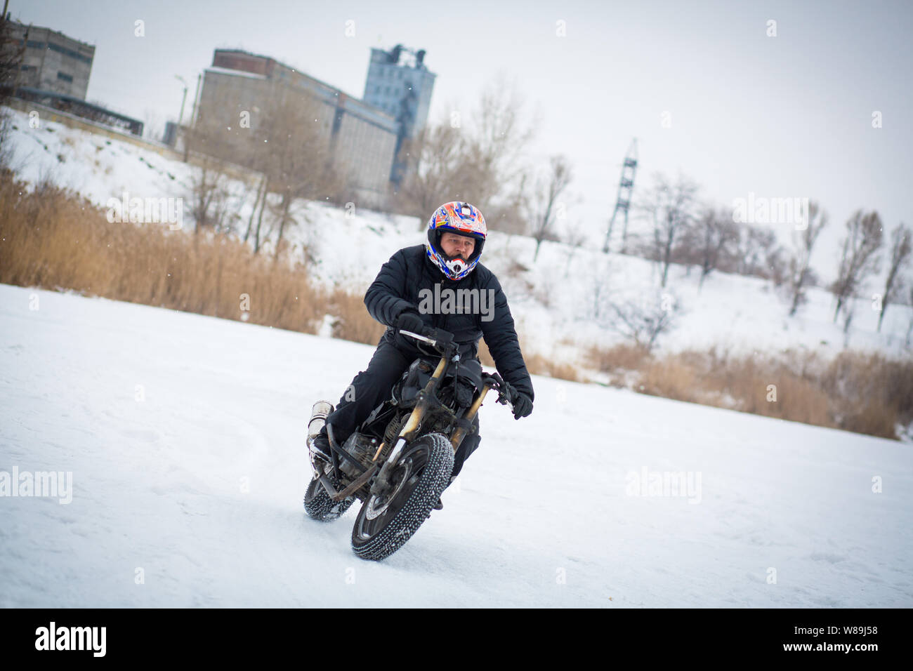 A guy rides a motorcycle on a frozen lake Stock Photo - Alamy