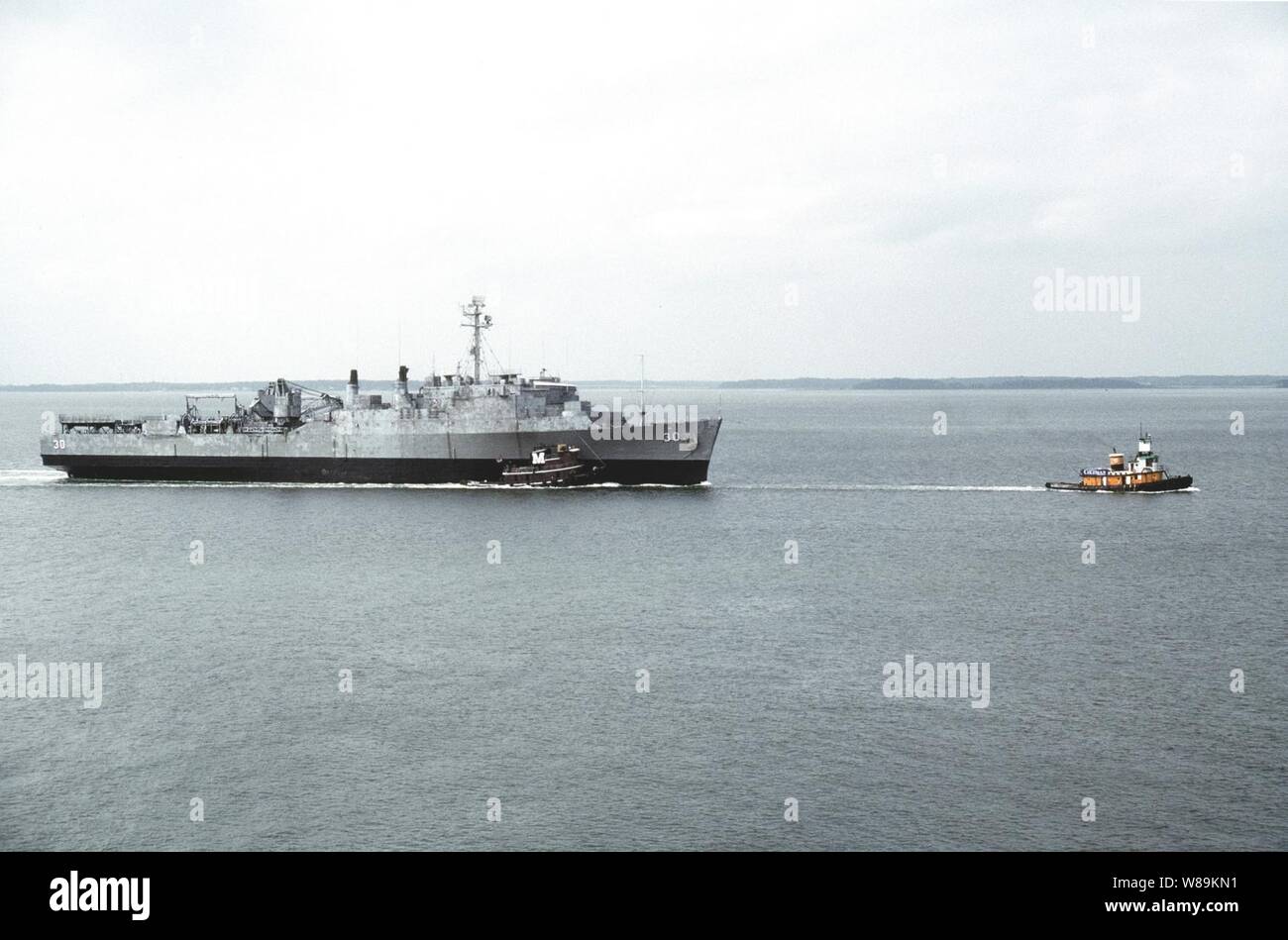 Decommissioned USS Fort Snelling (LSD-30) is towed on the James River ...