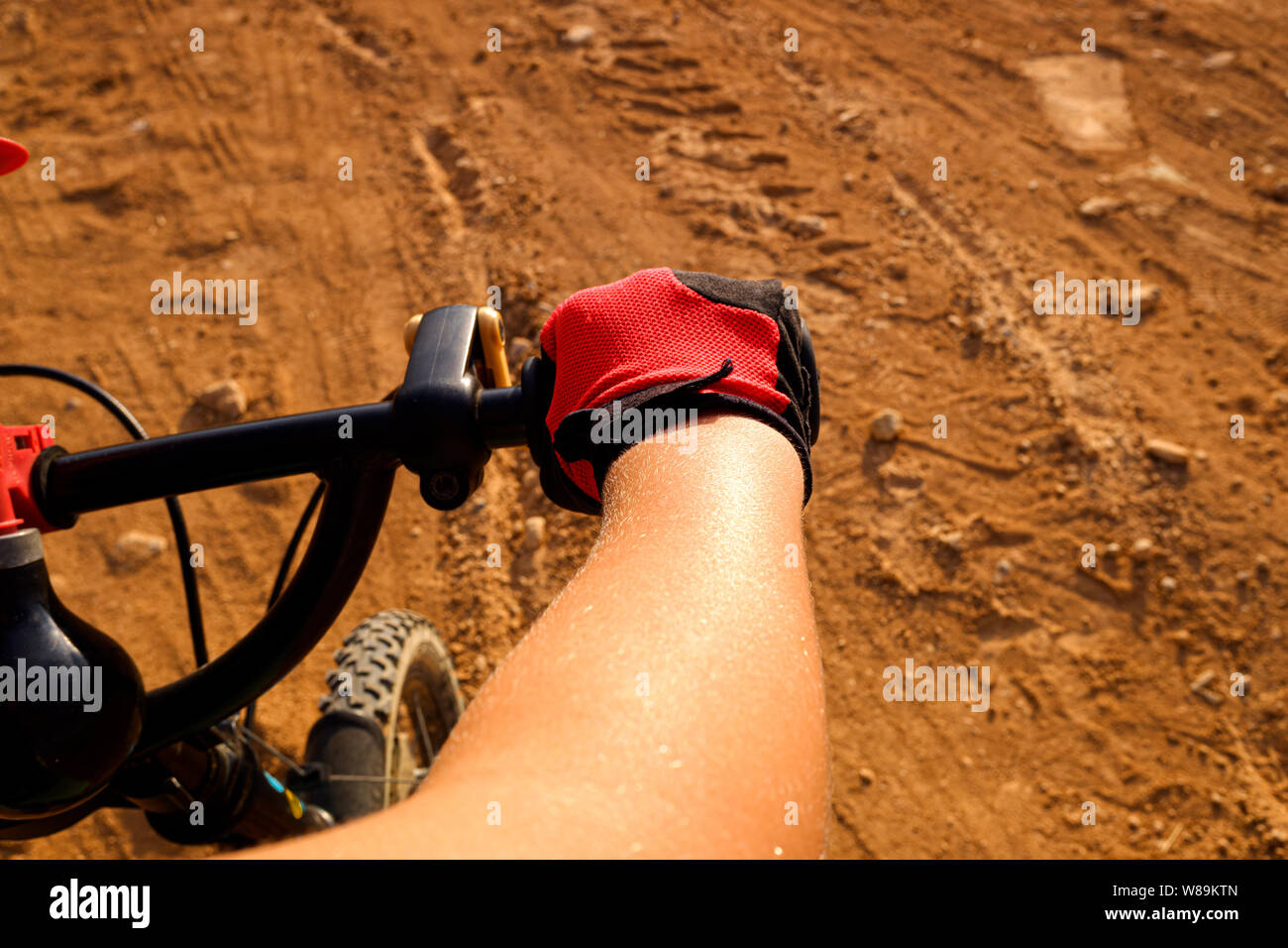 Young boy riding bicycle with training wheels hi-res stock photography ...
