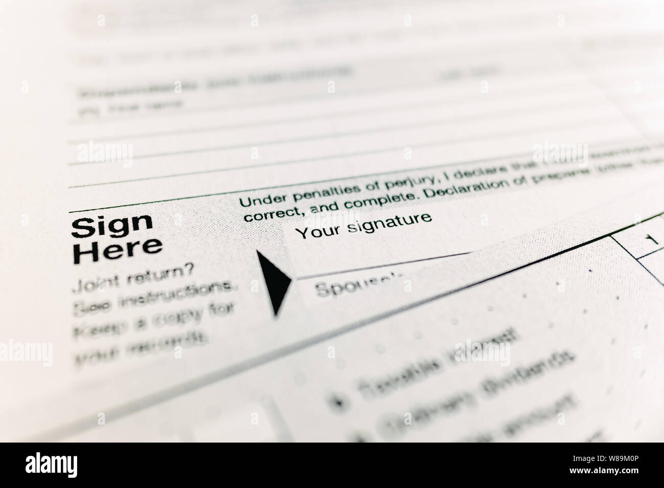 Sign here text on a government tax form Stock Photo - Alamy
