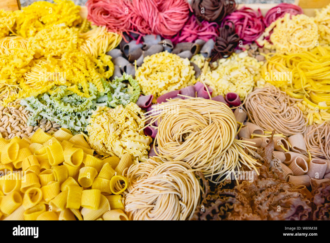 Many types of uncooked Italian pasta of various colors and shapes Stock ...