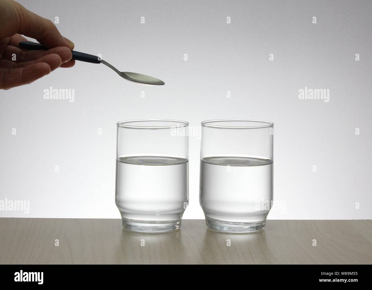 Two cup of water showing the solubility adding aspirin Stock Photo - Alamy