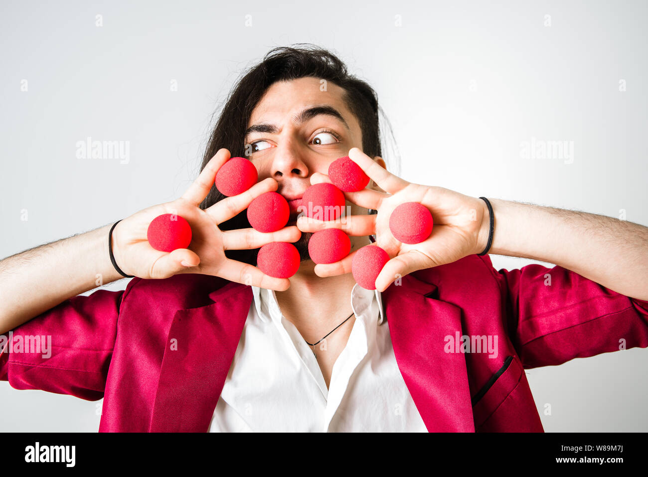 Magician with red balls in his outstretched hands Stock Photo - Alamy