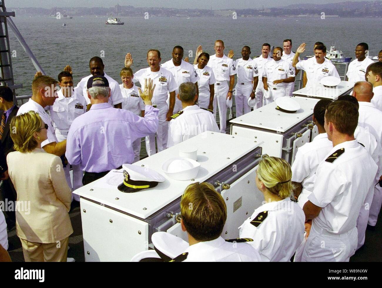 President Bill Clinton (in blue shirt) reads the oath of re-enlistment ...