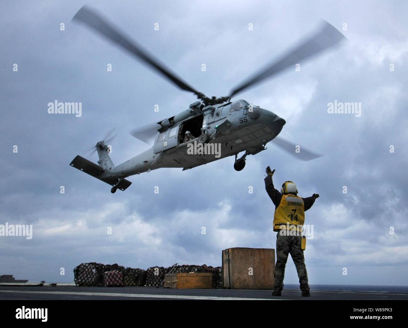 Airman Matt Newell directs the pilot of MH-60S Knighthawk helicopter ...