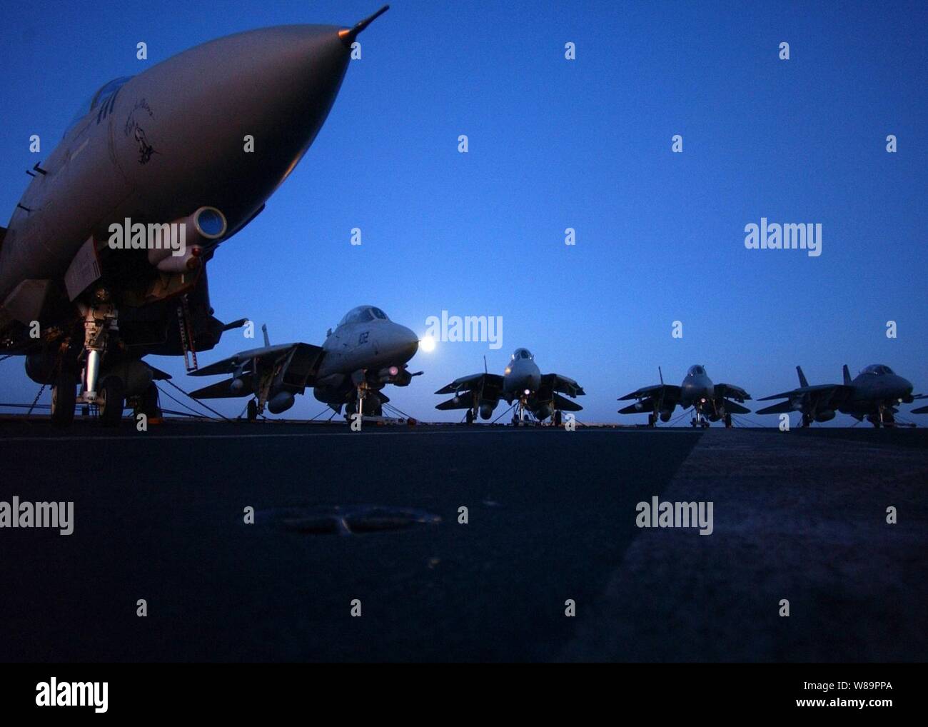 Five Navy F-14B Tomcats are chained-down on the fantail of the aircraft ...