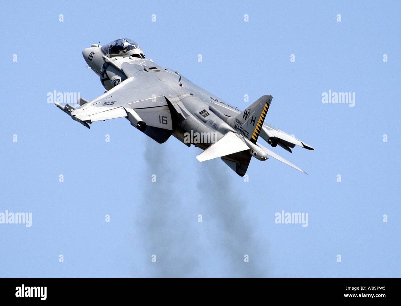 An AV-8B Harrier II takes off nearly vertical during a flight ...