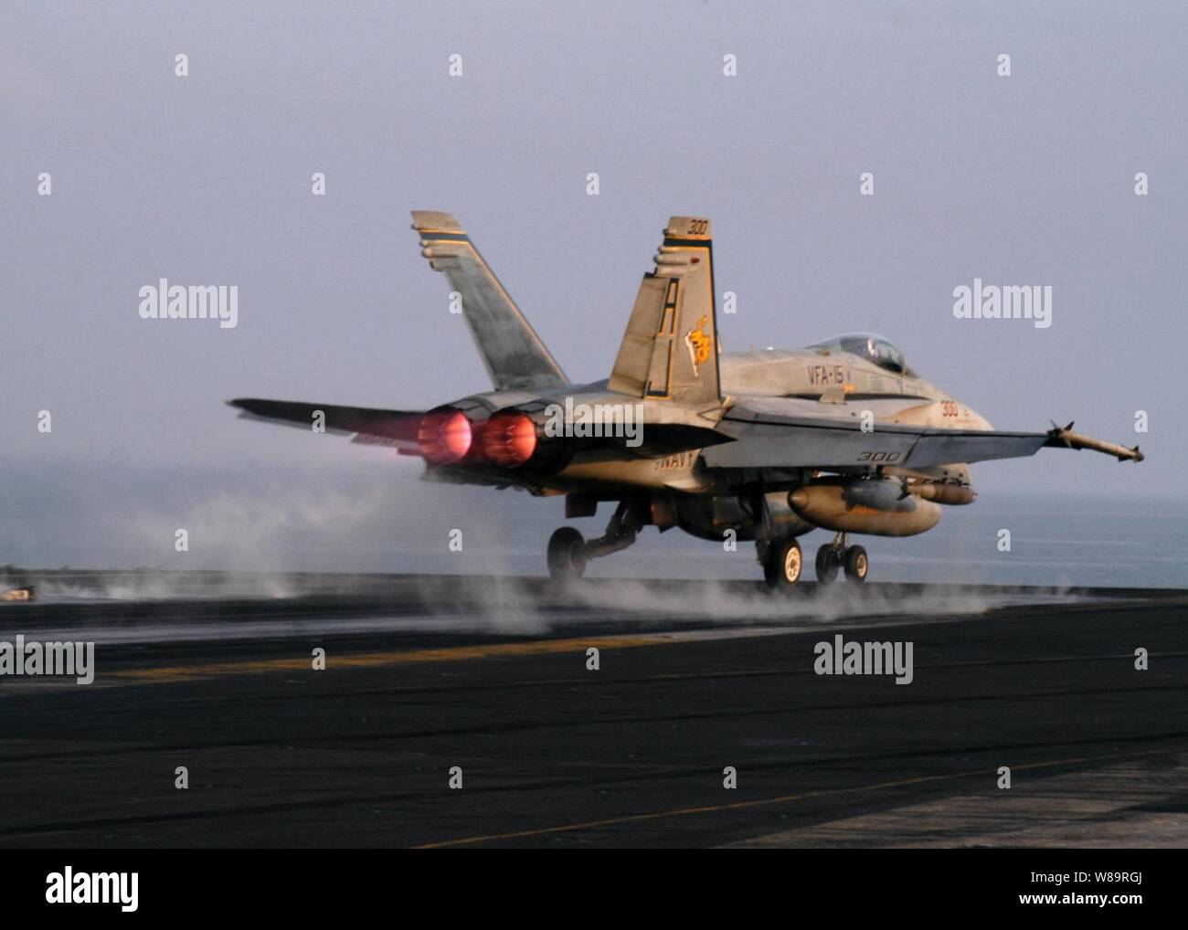 The afterburners glow on a U.S. Navy F/A-18 Hornet as it launches from ...