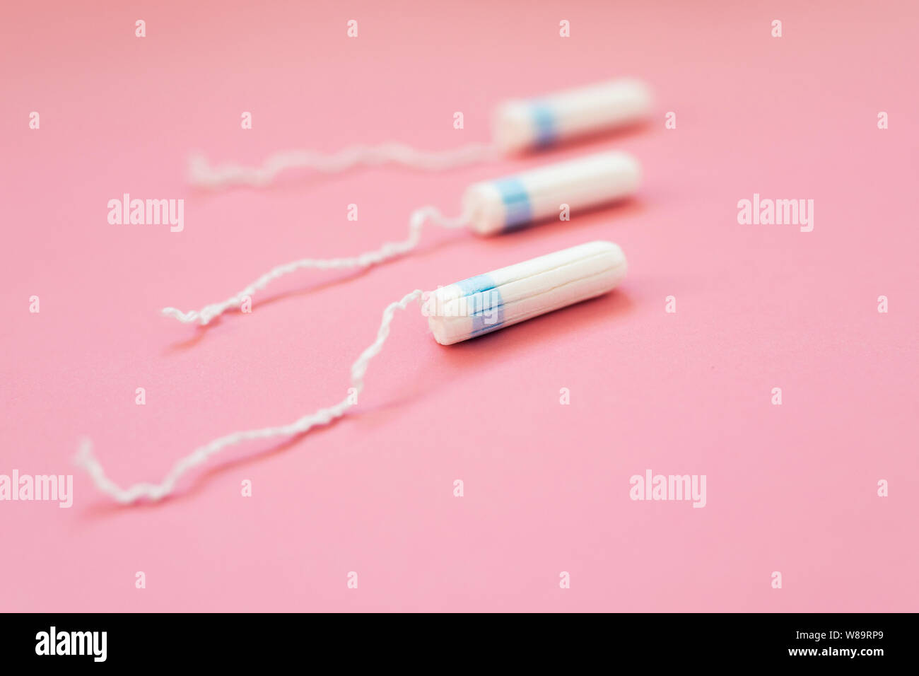 Medical female tampon on a pink background. Hygienic white tampon for ...