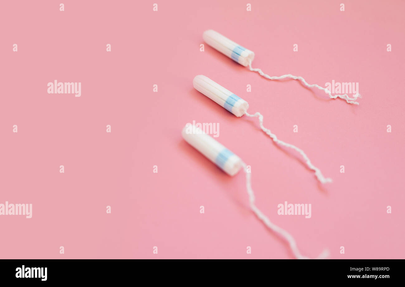 Medical female tampon on a pink background. Hygienic white tampon for ...