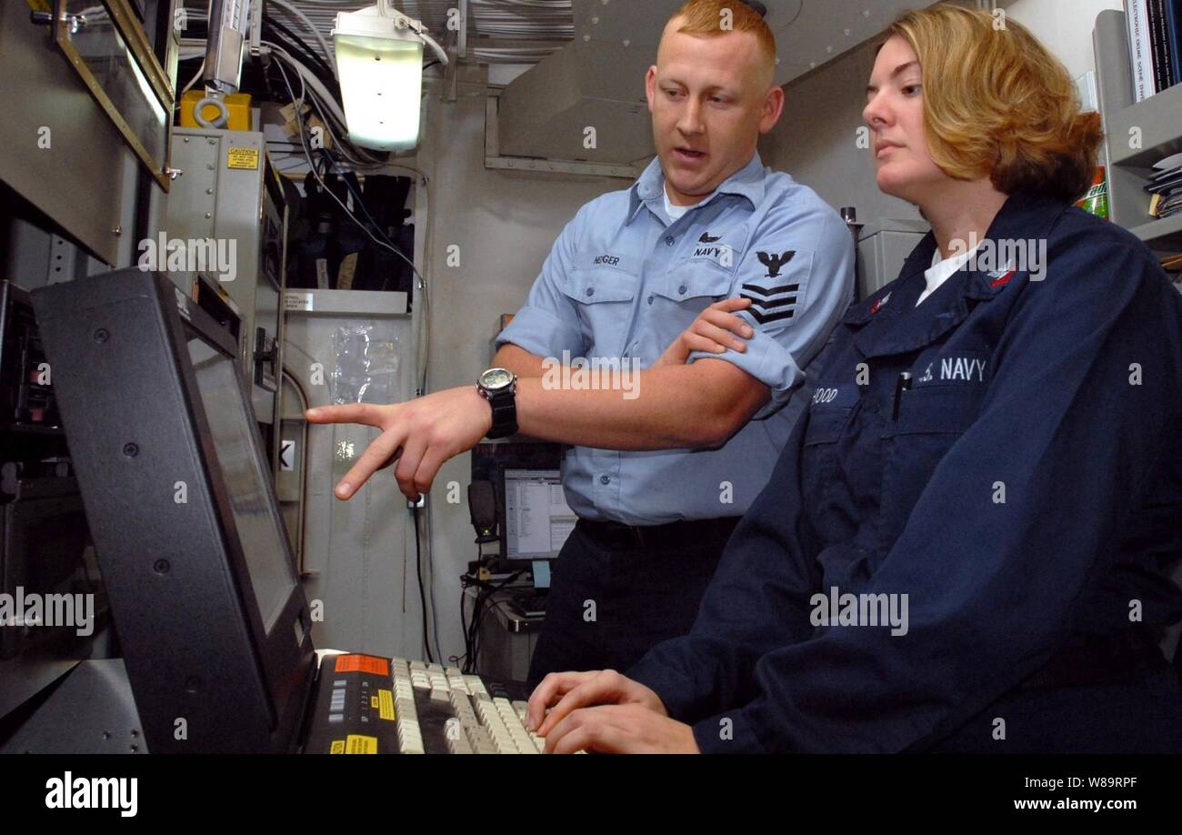 U.S. Navy Information Systems Technician 1st Class Chris Hedger (left ...
