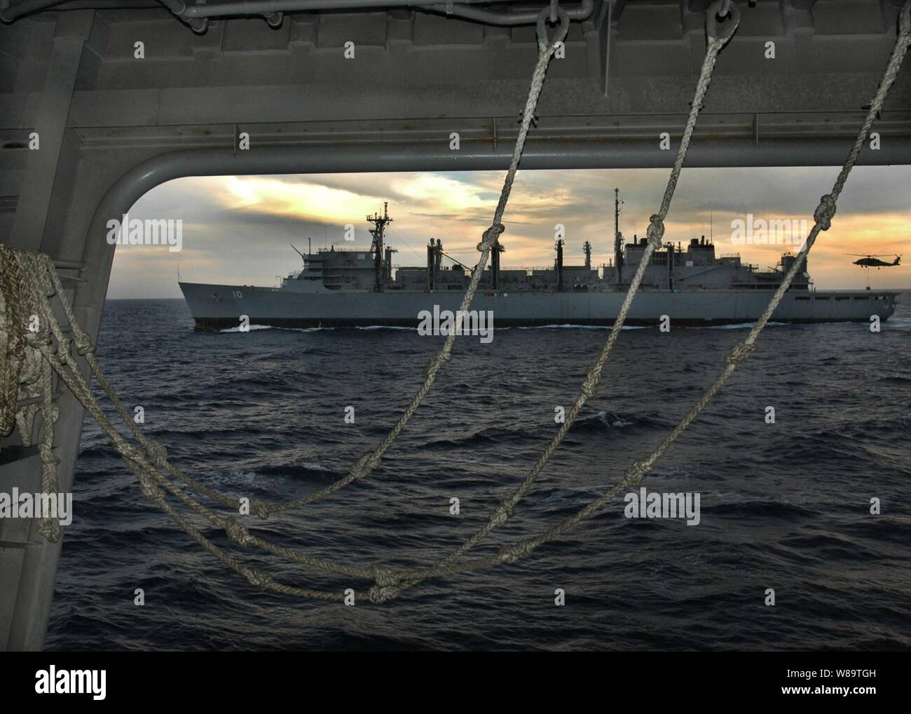 An HH-60H Seahawk helicopter delivers supplies to the USNS Bridge (T ...