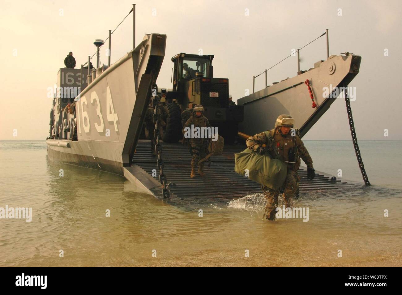 U.S. Marines from the 31st Marine Expeditionary Unit wade ashore at the ...