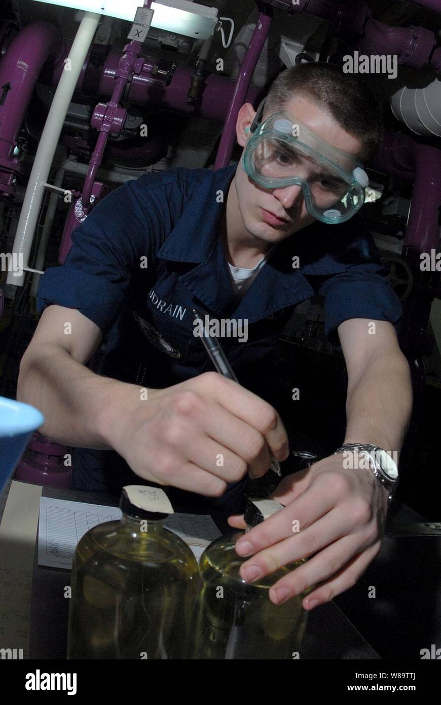 U.S. Navy Airman Nicholas Audrian labels aircraft fuel samples in the ...