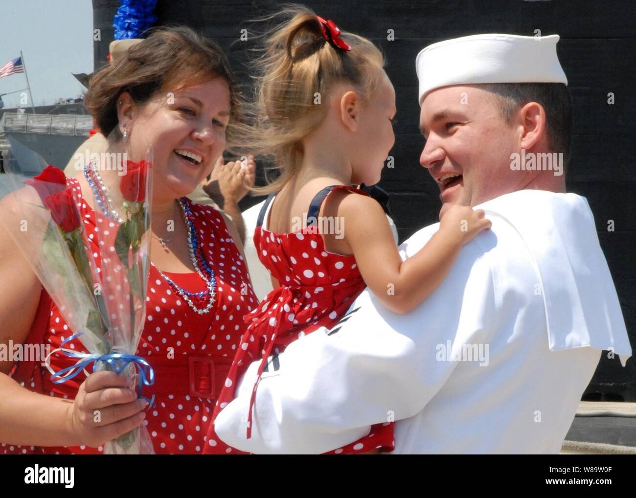 Navy Petty Officer 1st Class John Marsh greets his daughter and wife ...