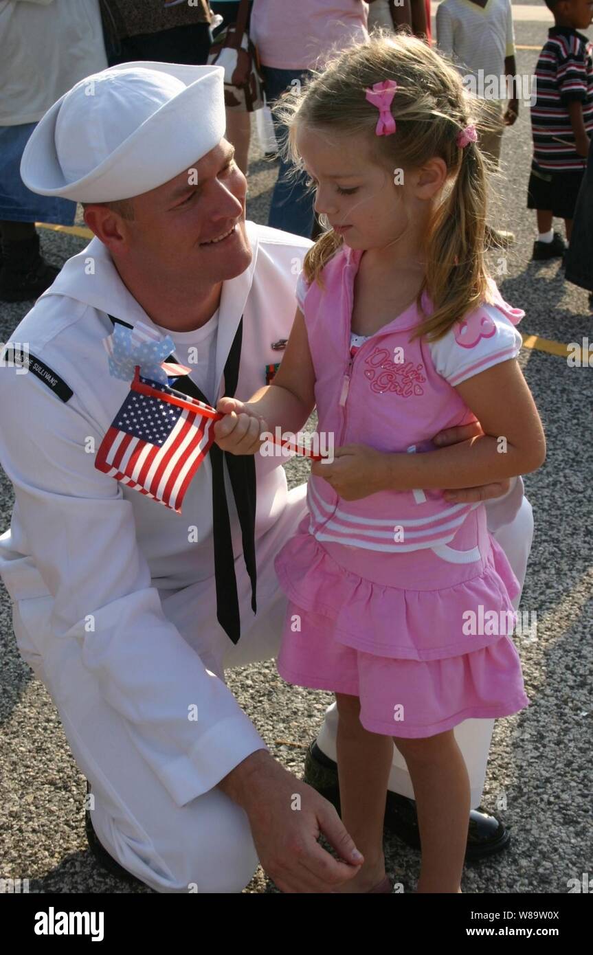 Petty Officer 1st Class David Couch greets his four-year-old daughter ...