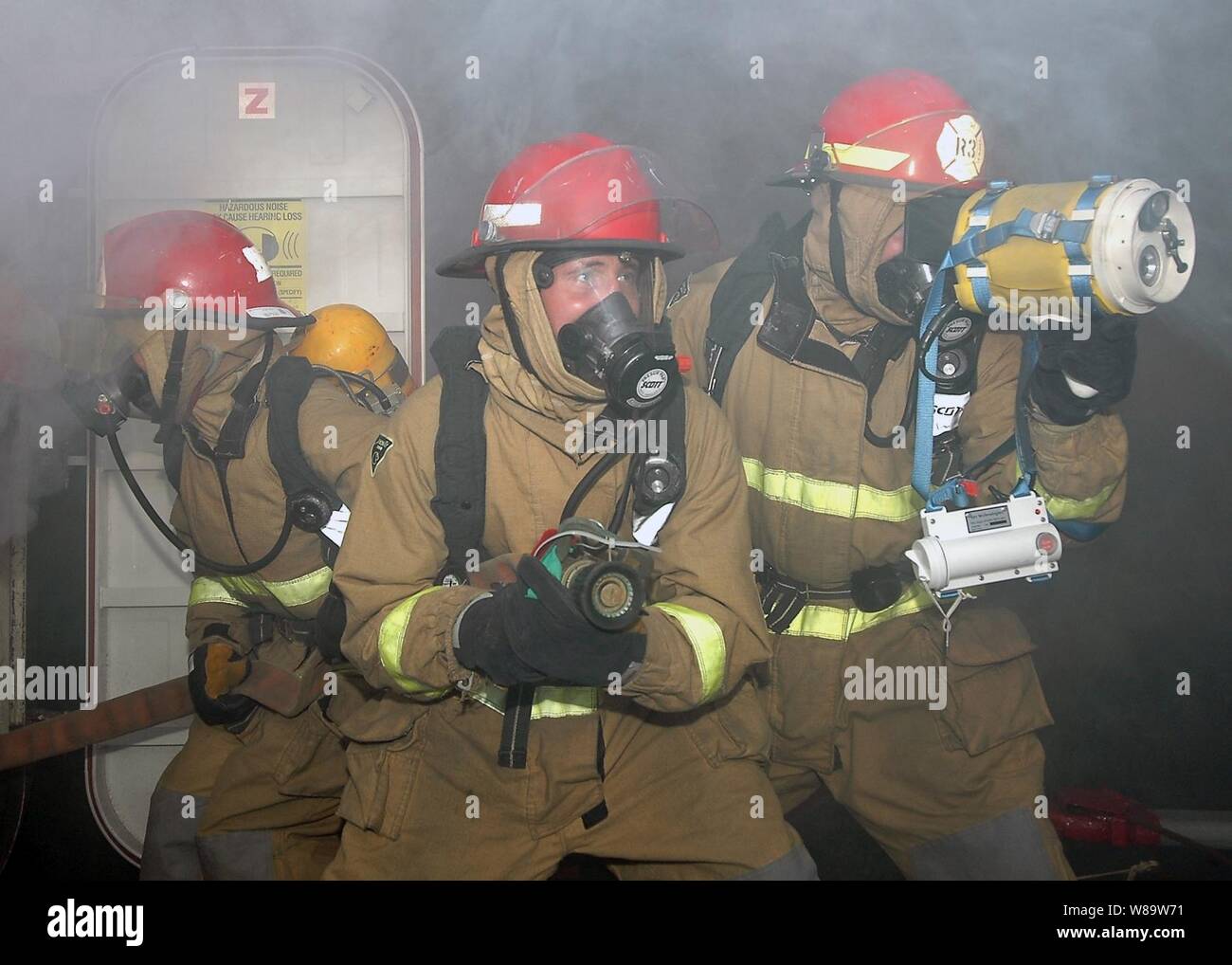U.S. Navy sailors fight a simulated class bravo fire during a general ...