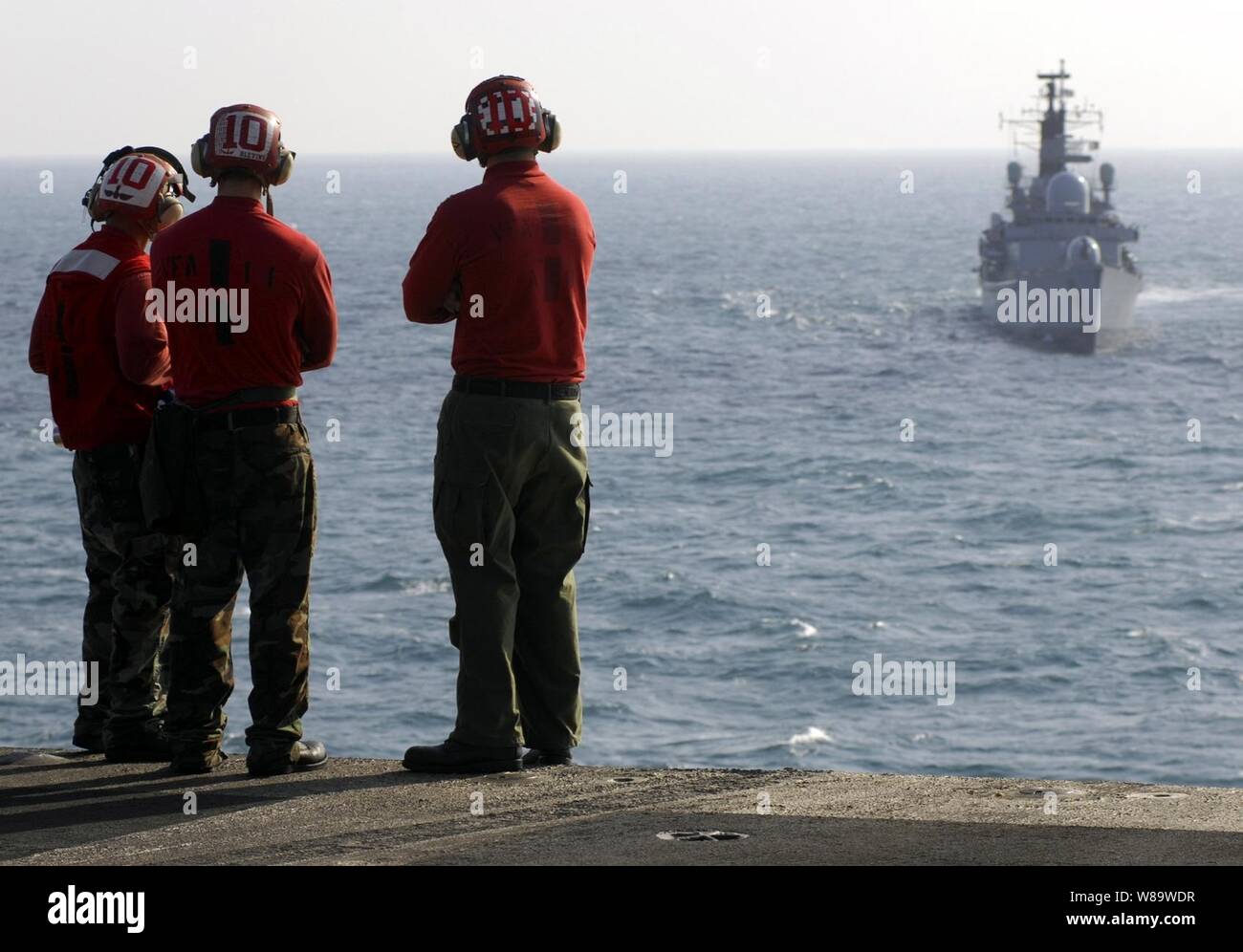 U.S. Navy Petty Officers Joshua Olaiz (left) Kyle Blevins (center) and ...
