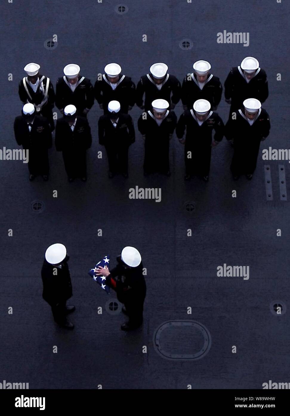 U.S. Navy sailors stand at attention as Senior Chief Storekeeper David ...