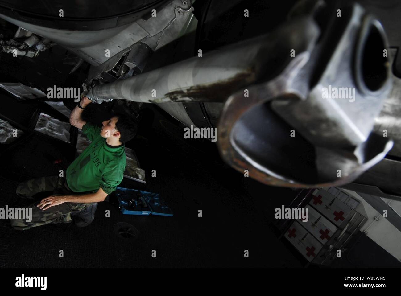 U.S. Navy Petty Officer 2nd Class Wesley Goodwin conducts maintenance ...