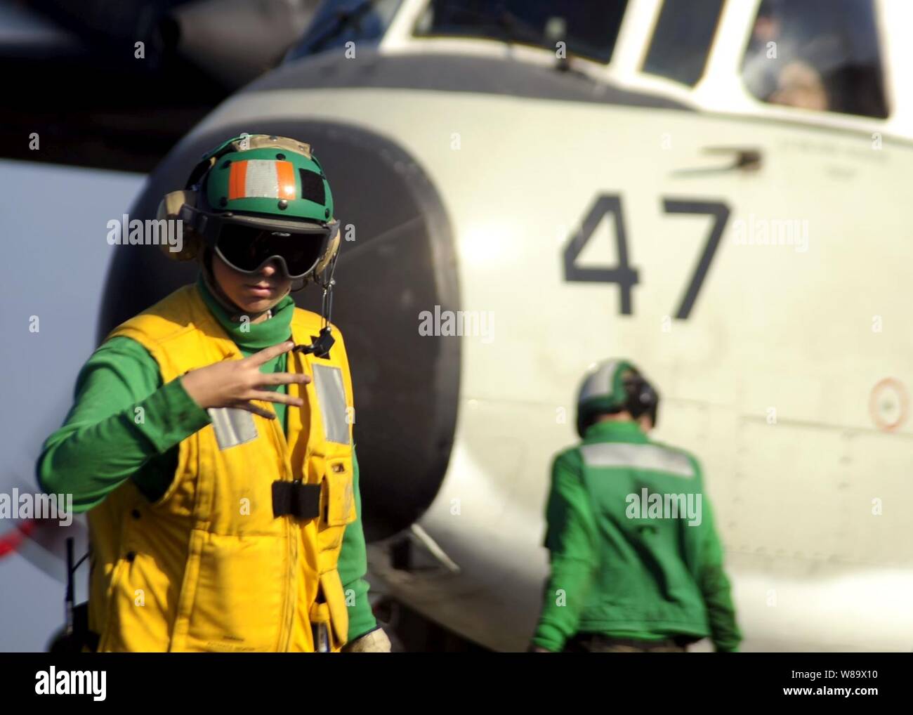 U.S. Navy Petty Officer 3rd Class Nancy Germann signals to a shooter ...