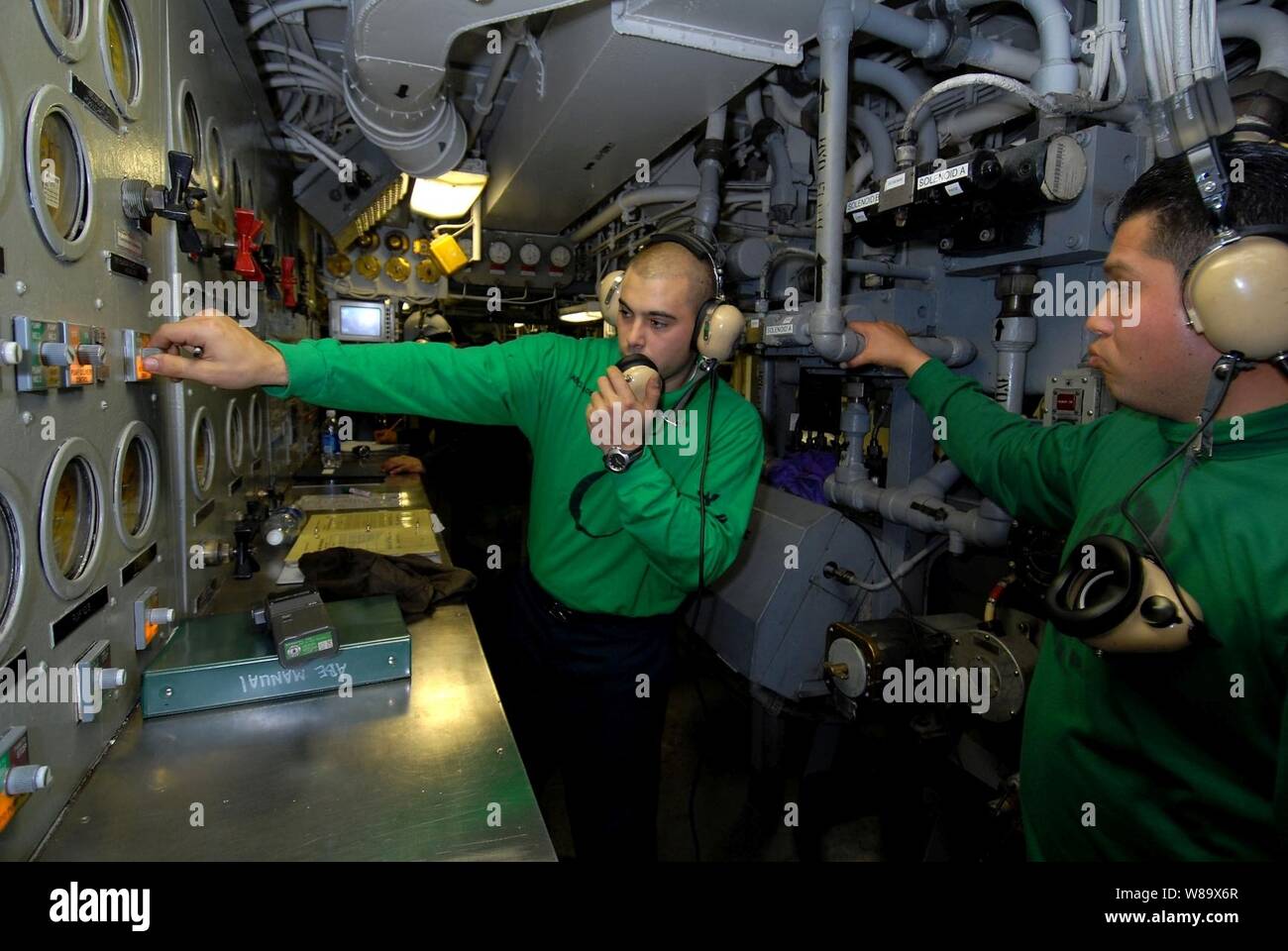 U.S. Navy Boatswain's Mates 2nd Class Marcus Rideout (left) and Abraham ...