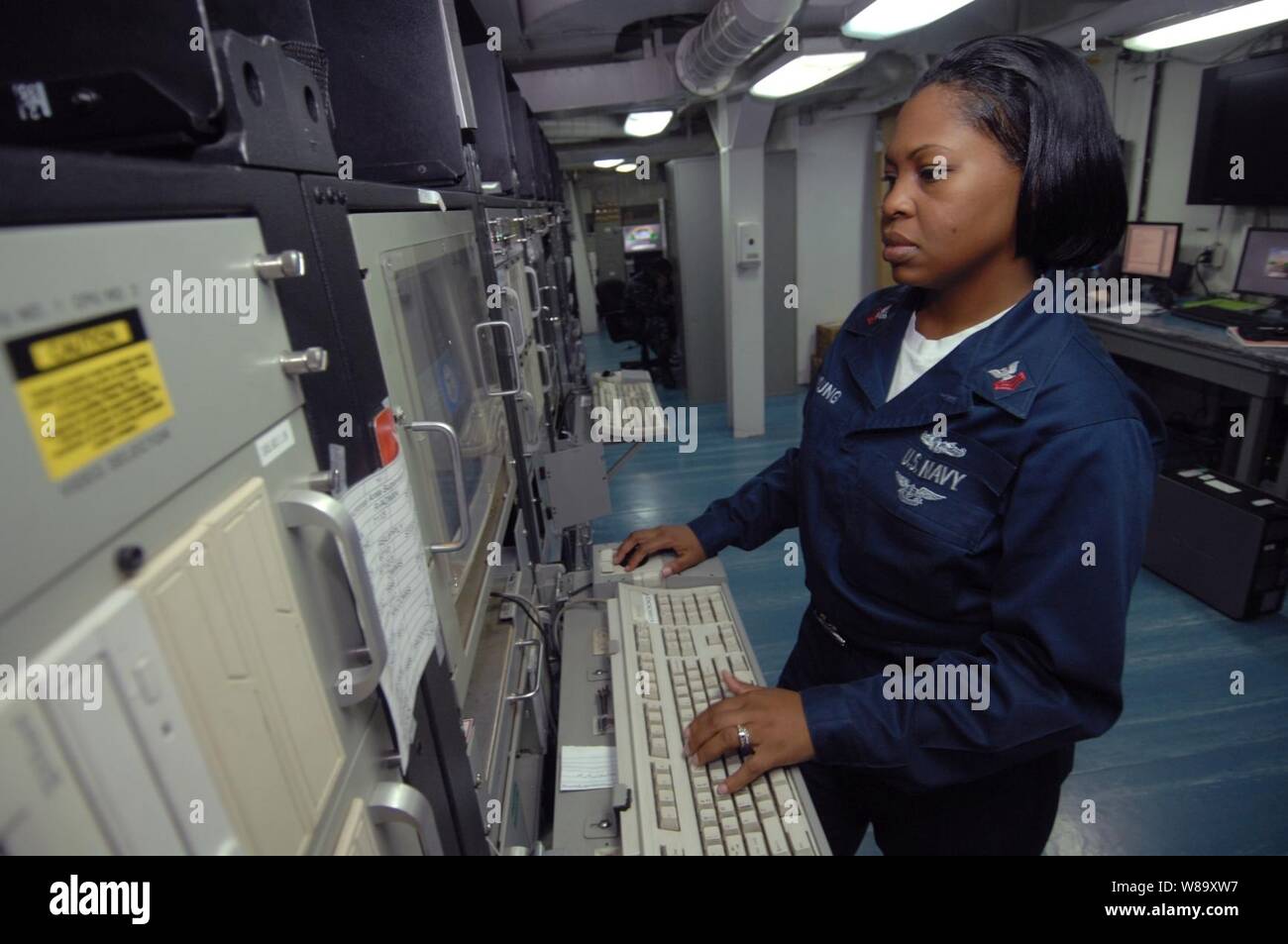 U.S. Navy Petty Officer 1st Class Lashandrea Young reviews the database ...