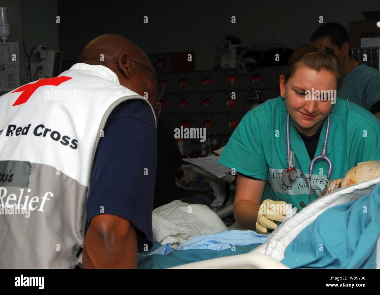 U.S. Navy Lt. Lindsay Touchette (right) cares for a burn victim in an ...