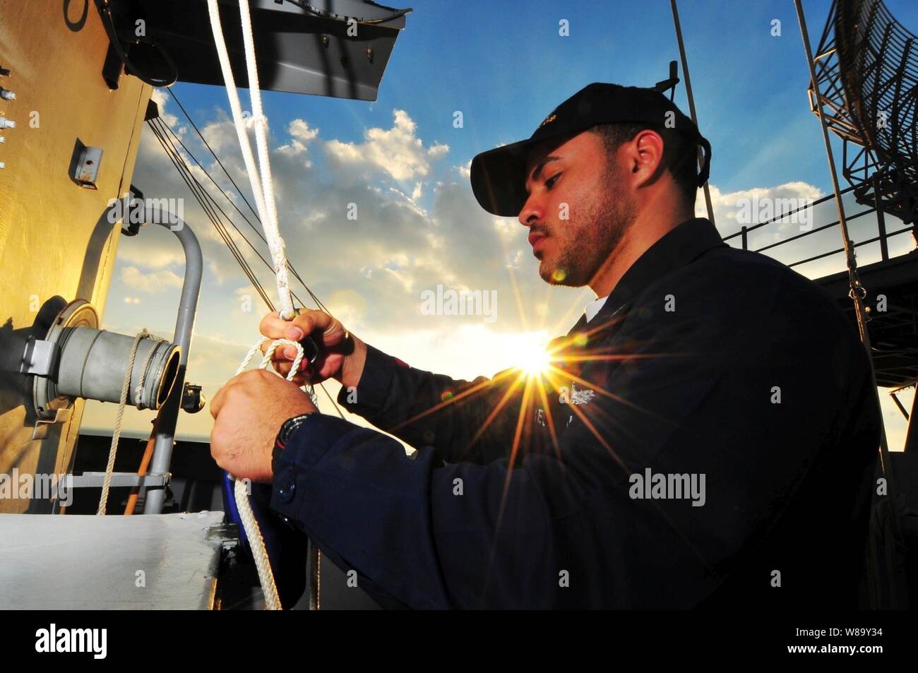 U.S. Navy Petty Officer 3rd Class Luis Torres prepares to hoist the ...