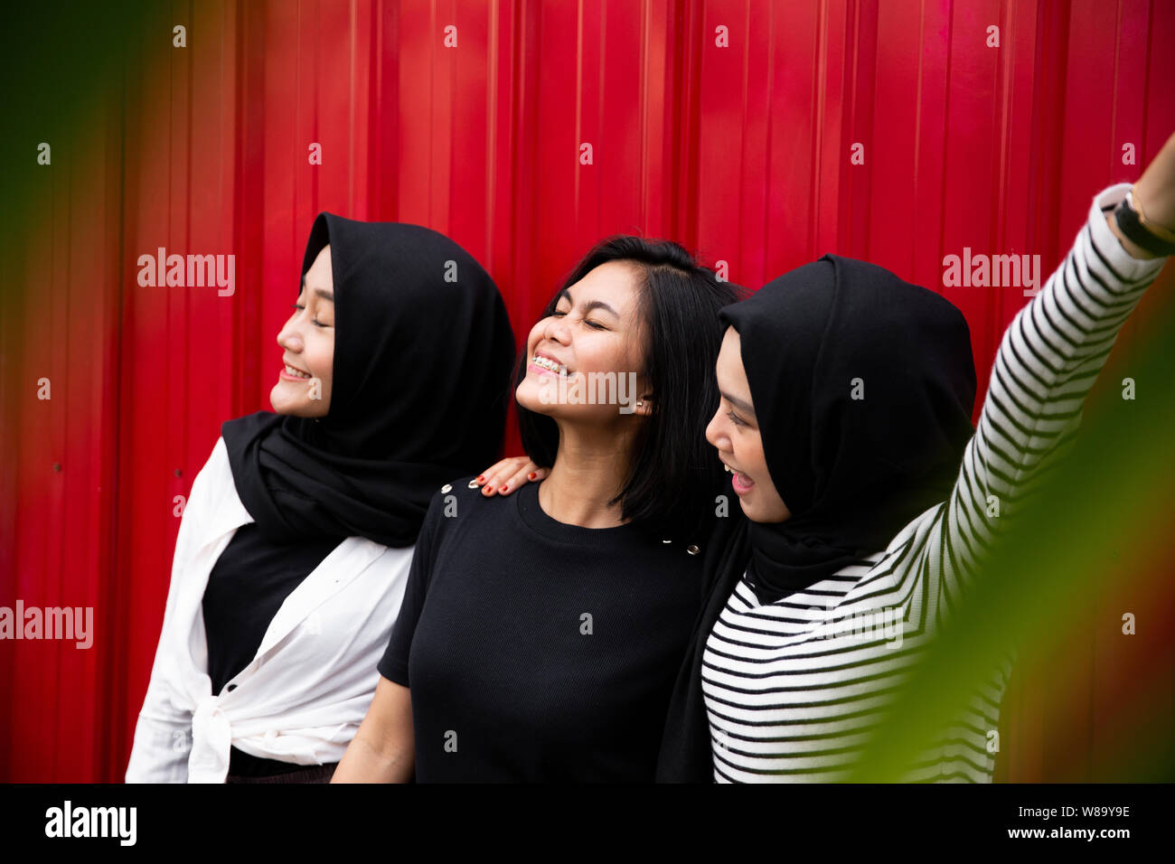 three women standing pose Stock Photo - Alamy