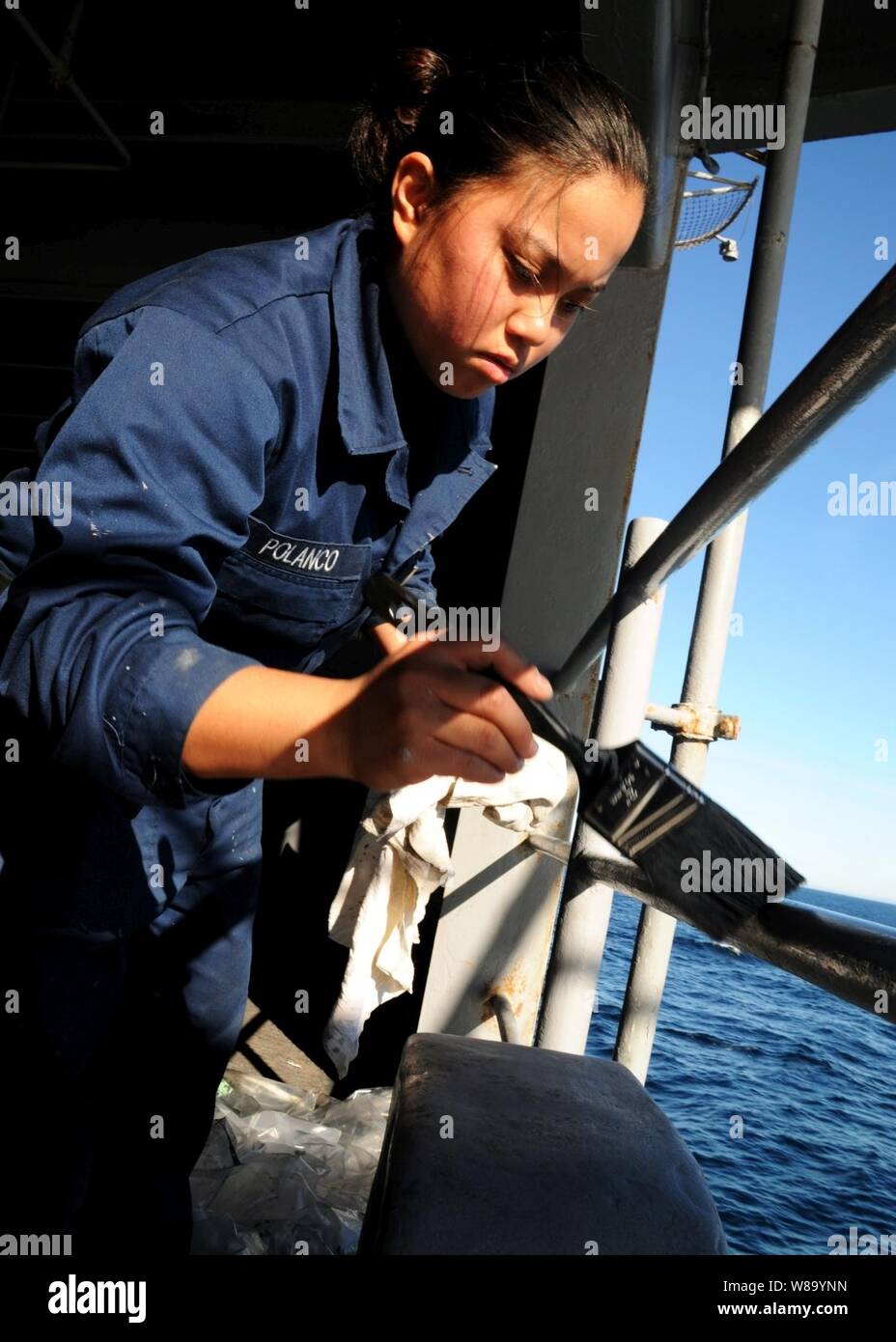 U.S. Navy Seaman Whitney A. Polanco paints handrails on the fantail of ...