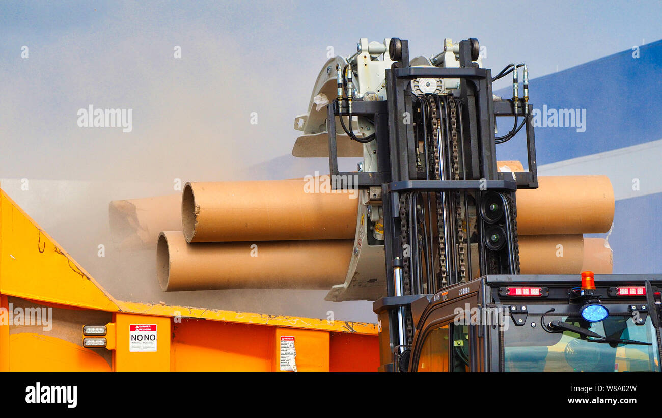 Large cardboard tubes being loaded into a grinder Stock Photo - Alamy